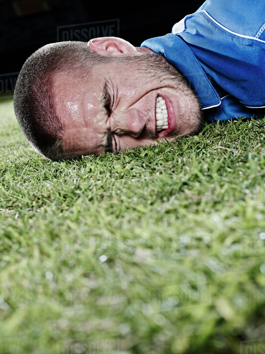 Soccer player falling on field - Royalty-free Stock Photo | Dissolve
