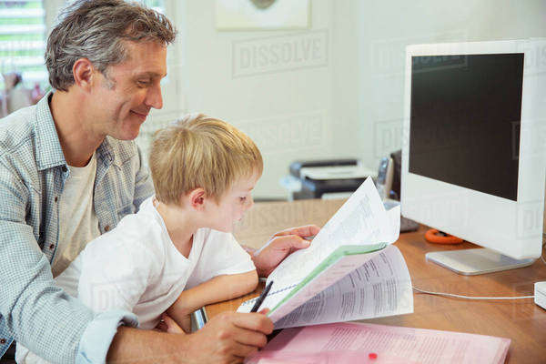 Father and son working in home office - Royalty-free Stock Photo | Dissolve