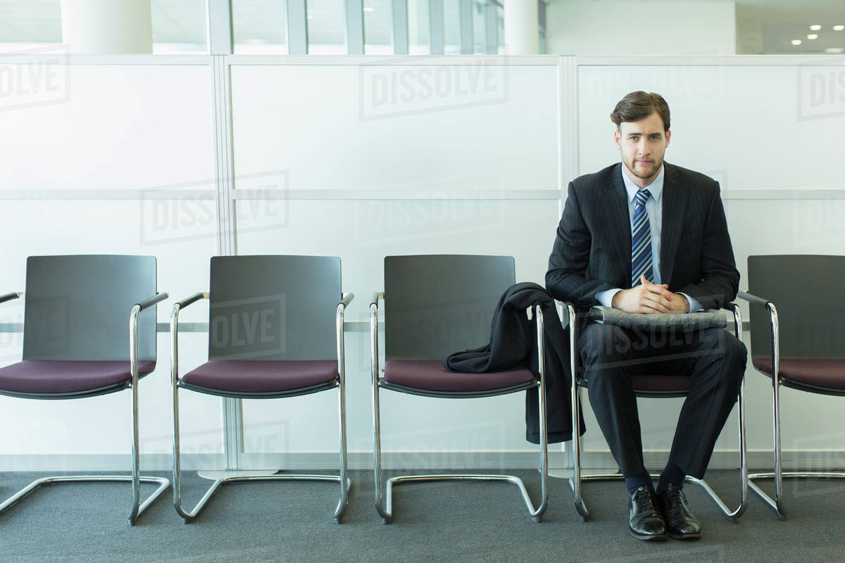 Businessman sitting in waiting area - Royalty-free Stock Photo | Dissolve