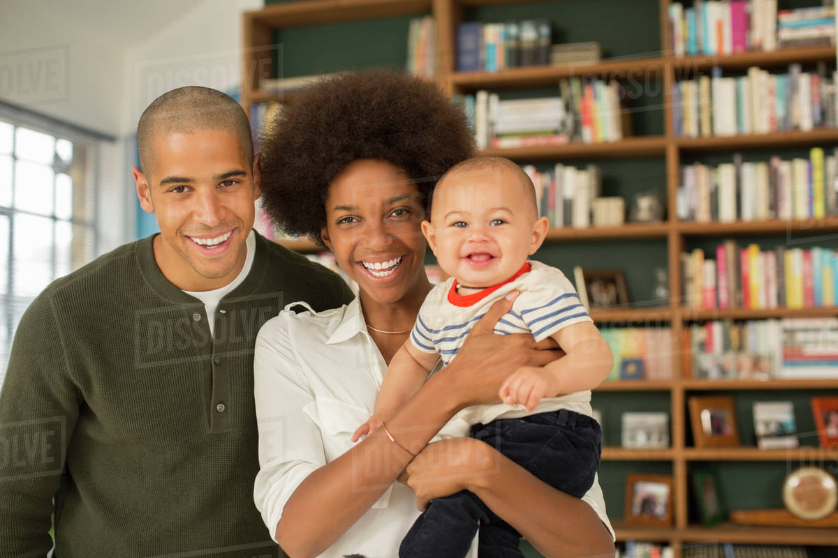 Family smiling together in living room - Royalty-free Stock Photo ...