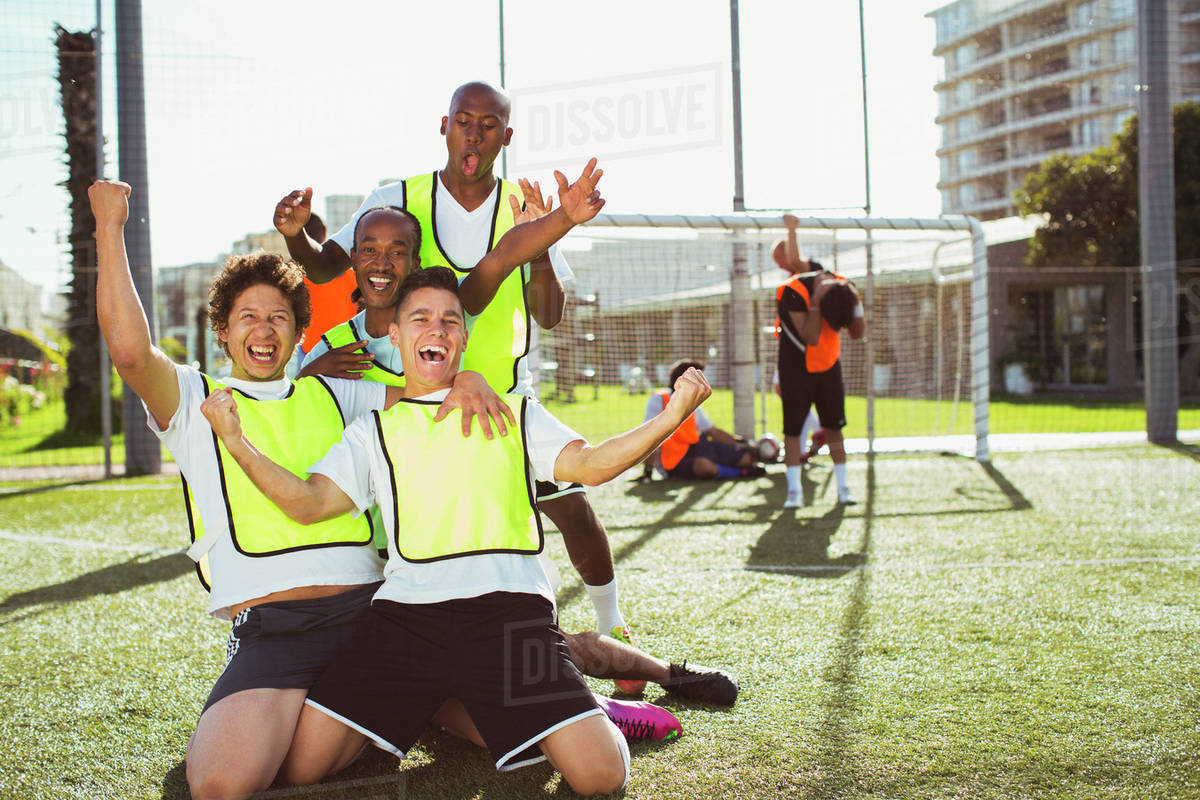 Soccer players cheering on field - Royalty-free Stock Photo | Dissolve