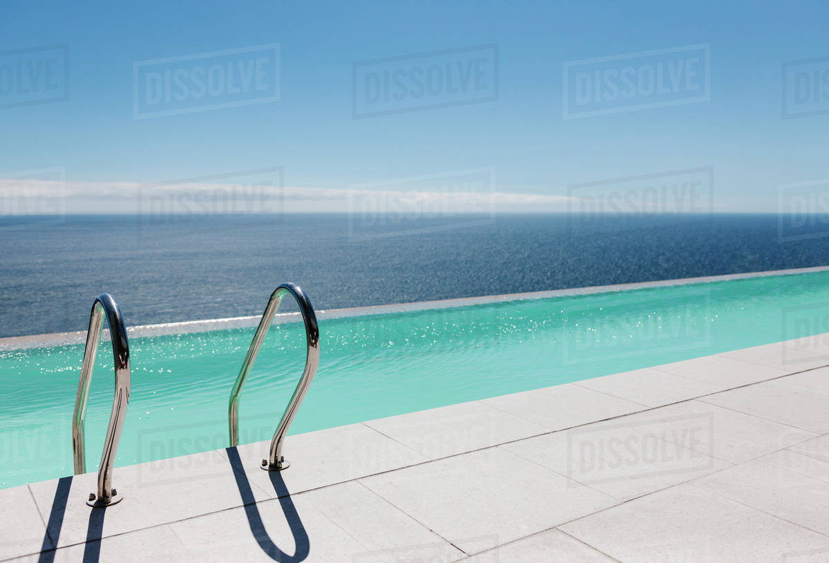 Infinity pool overlooking ocean - Stock Photo - Dissolve