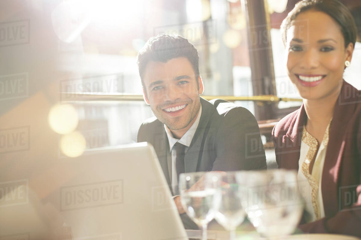 Business people smiling in restaurant - Royalty-free Stock Photo | Dissolve