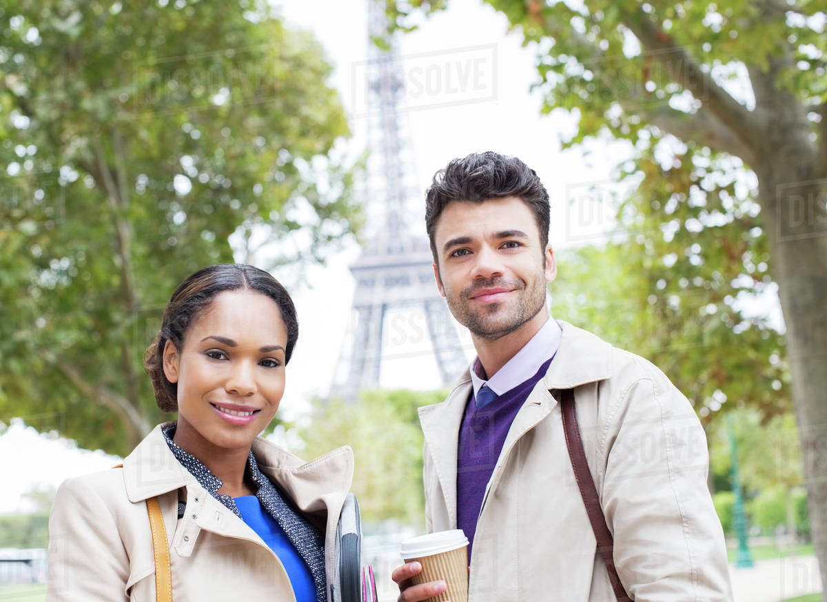 Business people smiling in park near Eiffel Tower, Paris, France ...