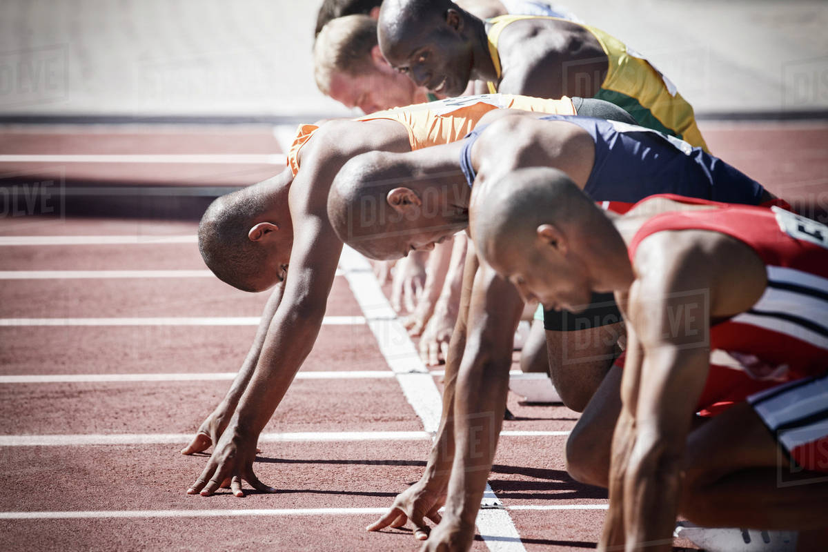 Runners preparing at starting line - Stock Photo - Dissolve
