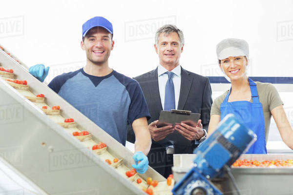 Portrait of supervisor and workers in food processing plant - Royalty ...