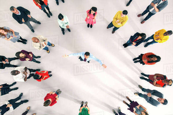 Crowd around businessman with arms outstretched - Royalty-free Stock ...