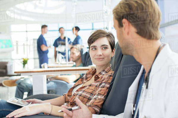 Doctor talking to patient undergoing medical treatment in outpatient ...