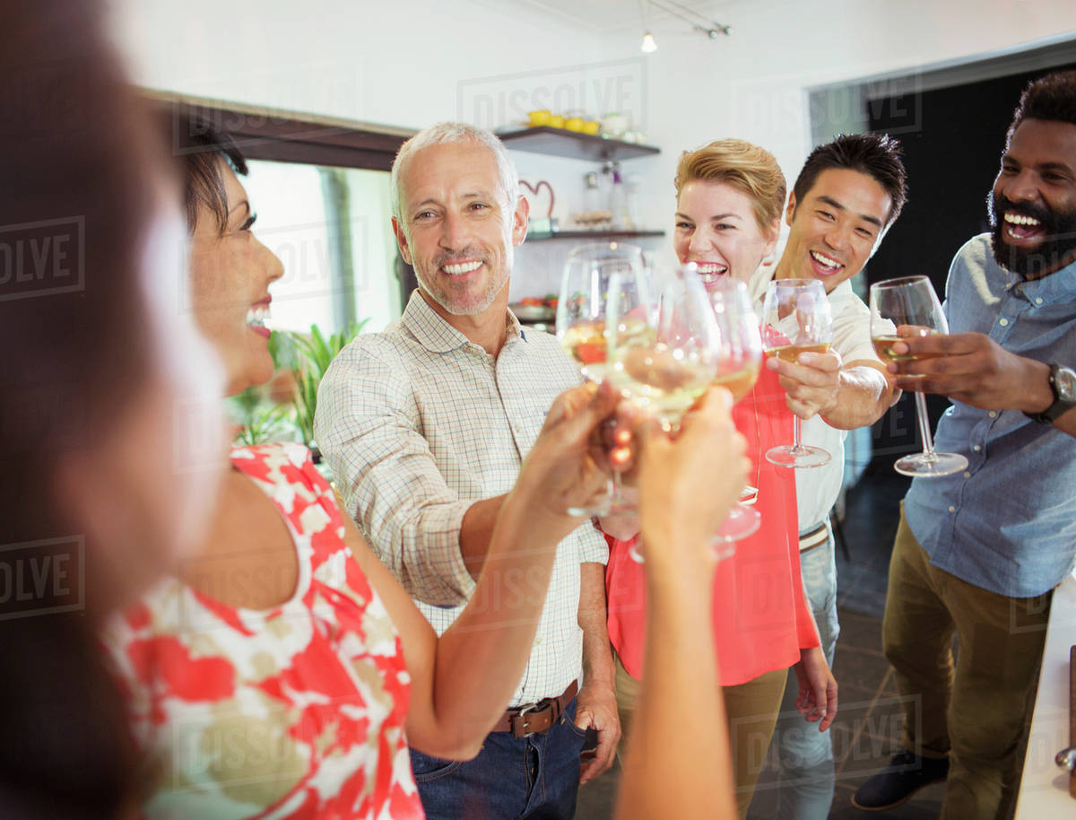 Friends toasting each other at party - Royalty-free Stock Photo | Dissolve