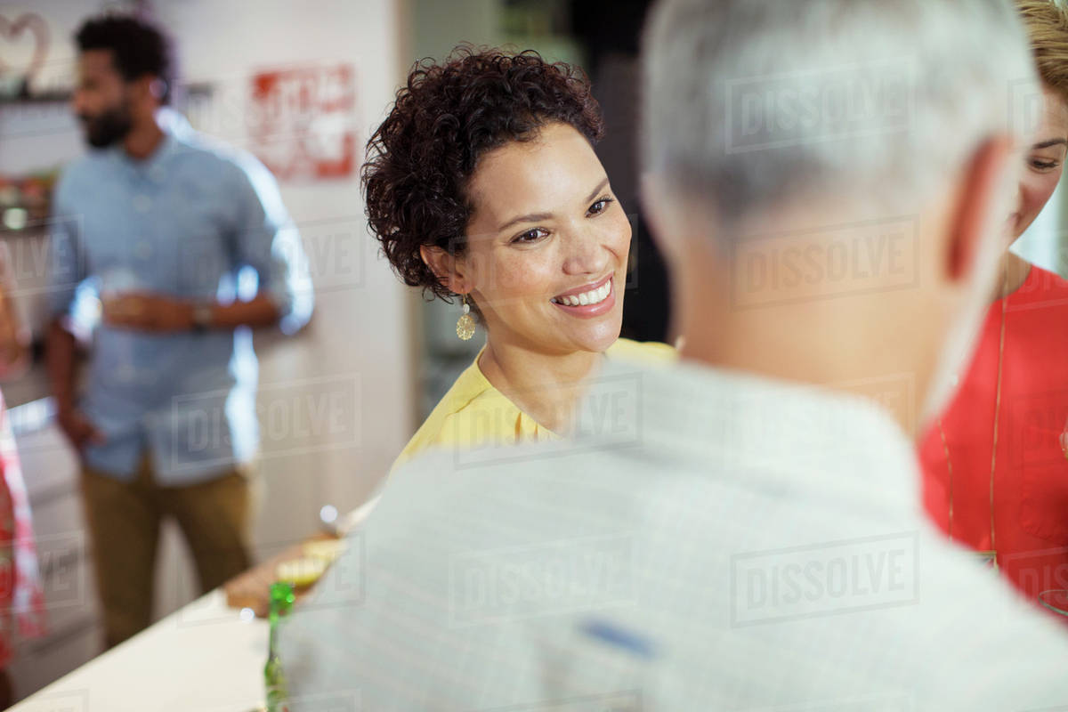 Woman smiling at party - Stock Photo - Dissolve
