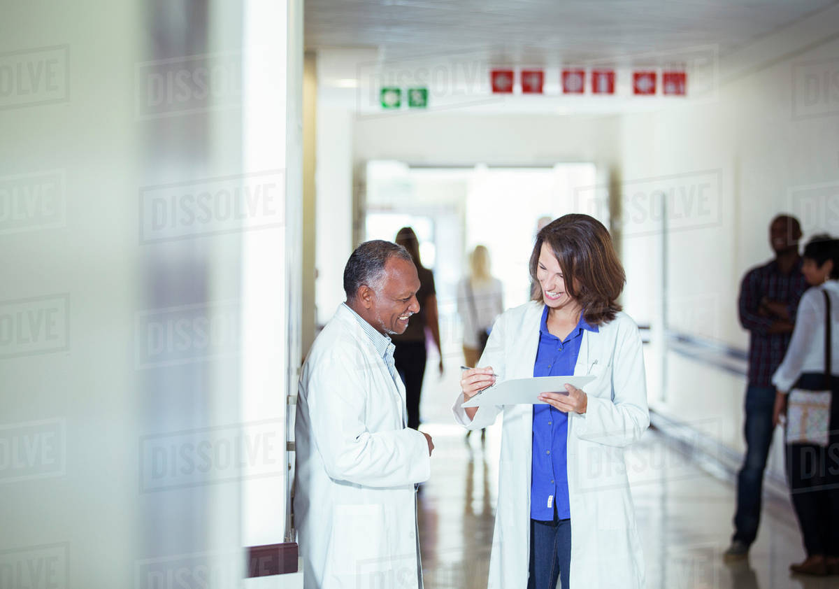 Doctors reading medical chart in hallway - Royalty-free Stock Photo ...