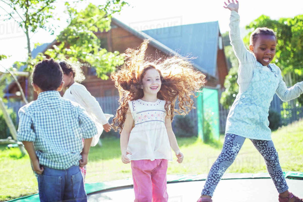 Children jumping on trampoline outdoors - Royalty-free Stock Photo ...