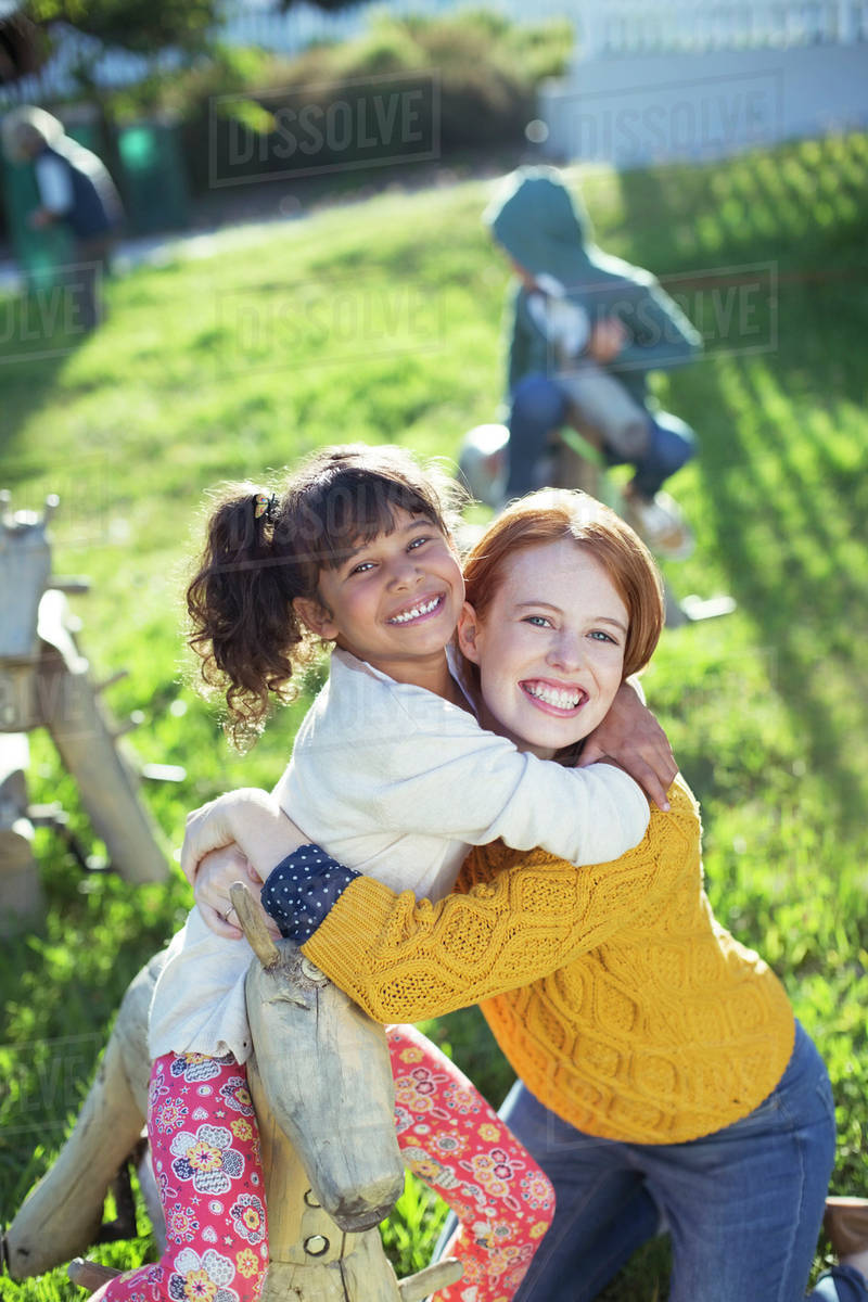 Student and teacher hugging outdoors - Royalty-free Stock Photo | Dissolve