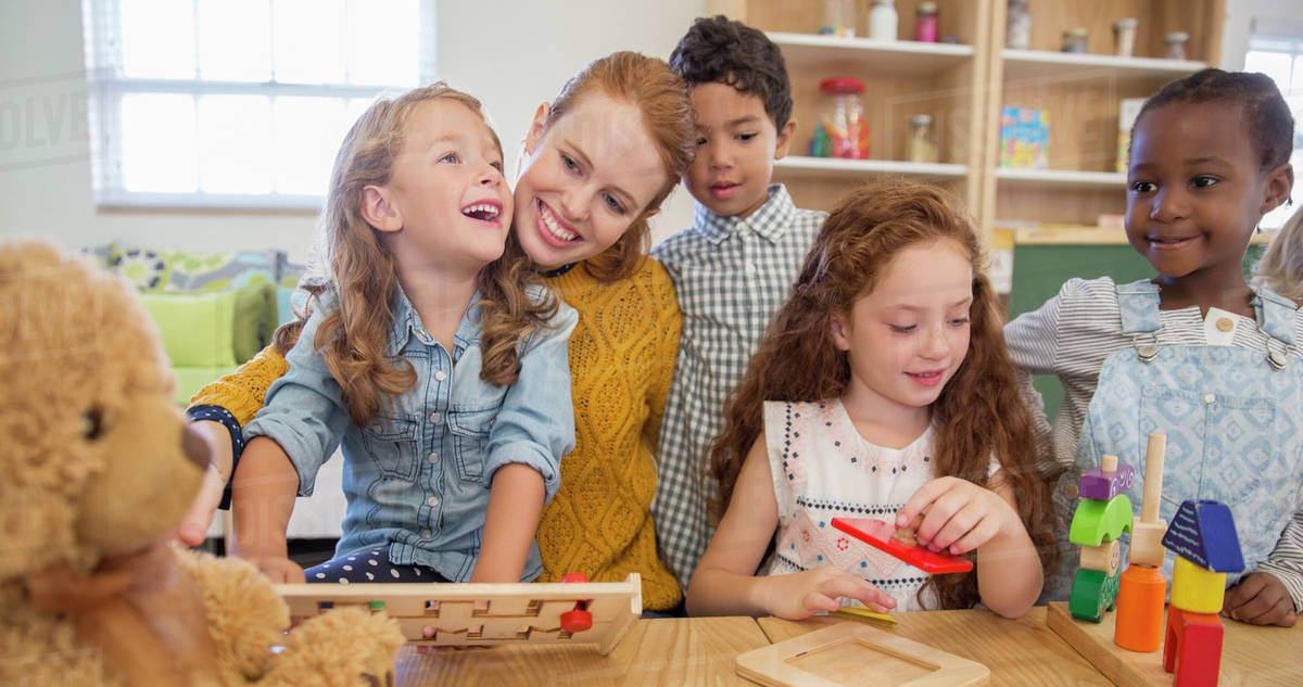 Students and teacher playing in classroom - Royalty-free Stock Photo ...
