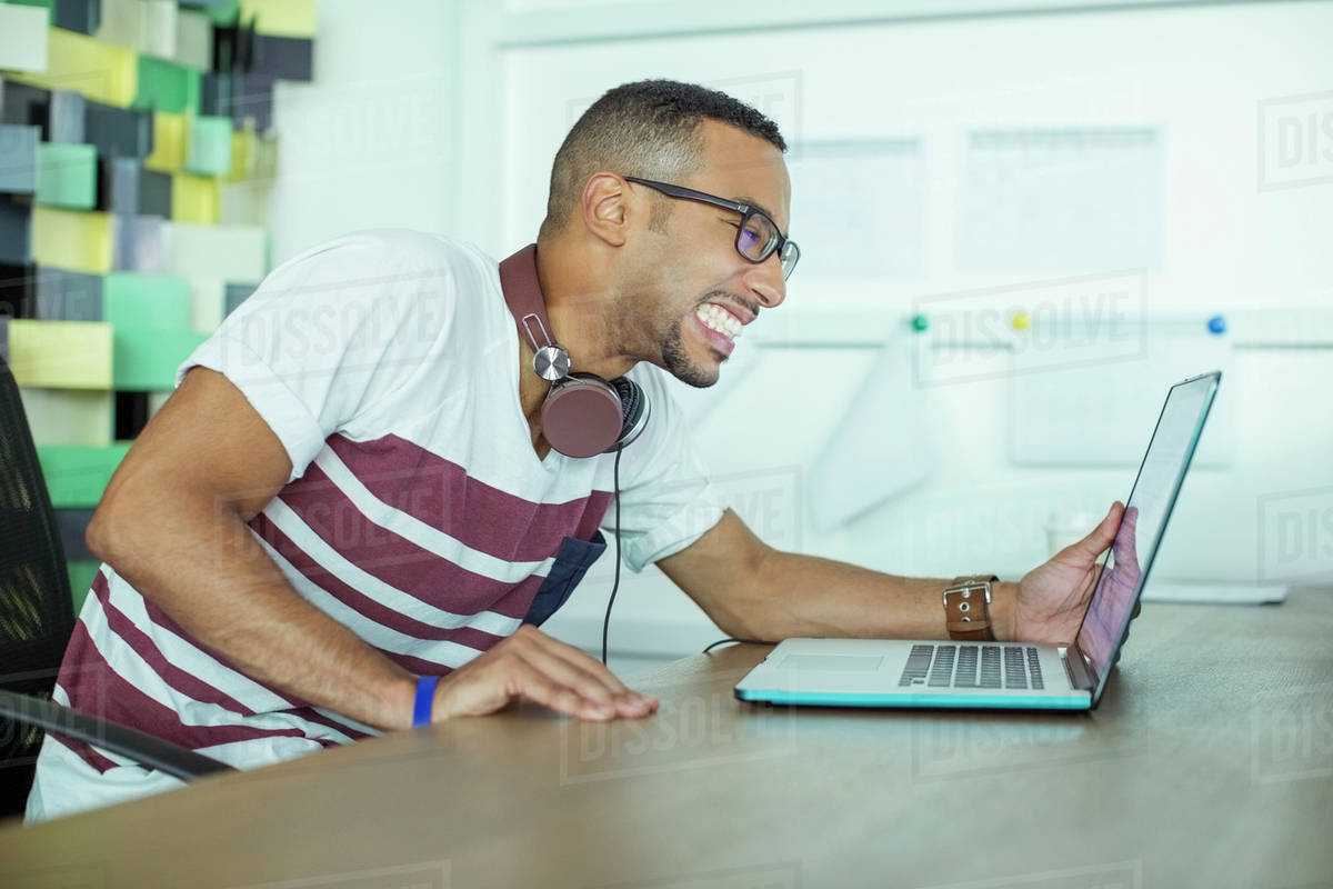 Man working at laptop in office - Royalty-free Stock Photo | Dissolve