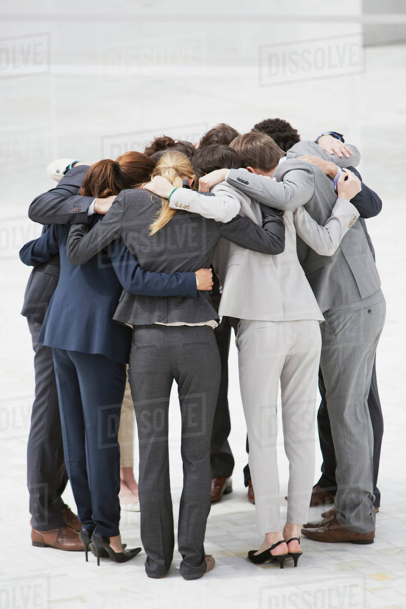 Business people in huddle - Stock Photo - Dissolve