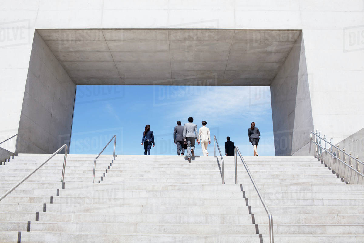 Business people ascending concrete steps toward blue sky - Stock Photo ...