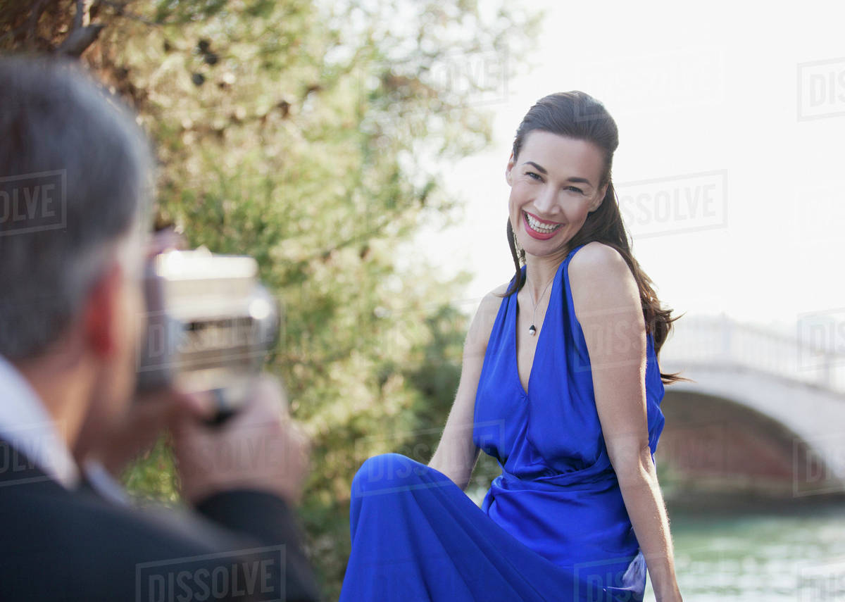 Man filming smiling woman - Royalty-free Stock Photo | Dissolve