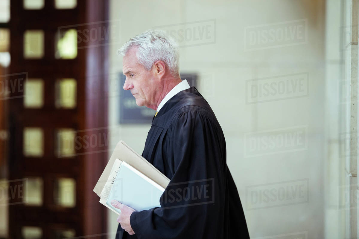 Judge walking through courthouse - Stock Photo - Dissolve
