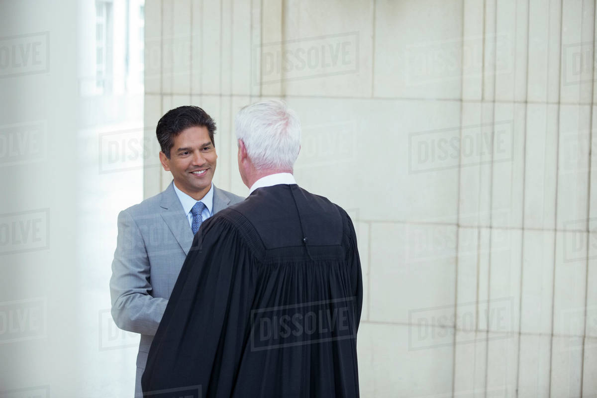 Lawyer and judge talking in courthouse - Royalty-free Stock Photo ...