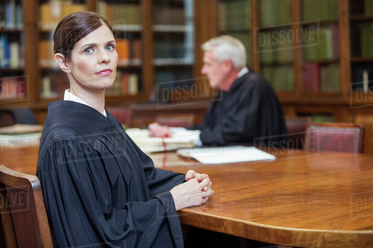 Lawyer sitting at meeting table in chambers - Royalty-free Stock Photo ...
