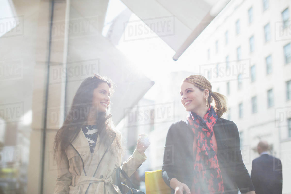 Women walking down city street together - Stock Photo - Dissolve Women walking down city street together - Stock Photo - Dissolve