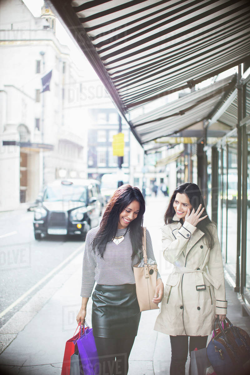Women walking down city street together - Royalty-free Stock Photo ...