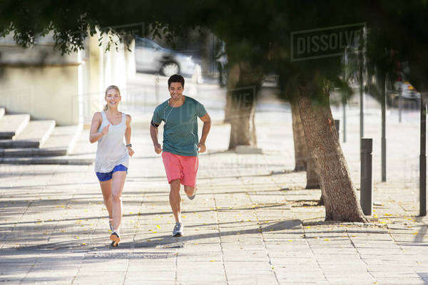 Couple running through city streets together - Royalty-free Stock Photo ...