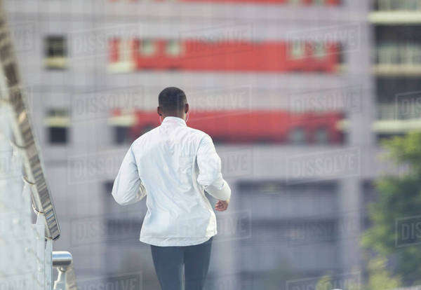 Man running through city street - Stock Photo - Dissolve