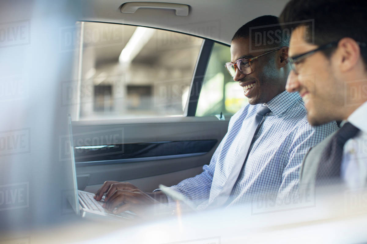 Businessmen using laptop in car - Royalty-free Stock Photo | Dissolve