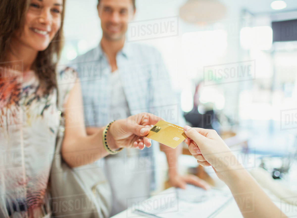 Close up of woman paying with credit card in store - Stock Photo - Dissolve