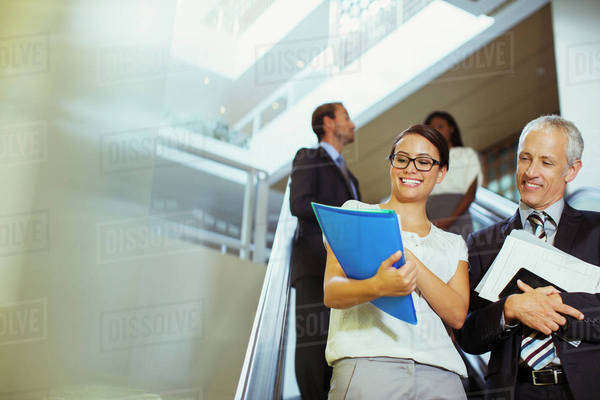 Business people looking over documents in office building - Stock Photo ...