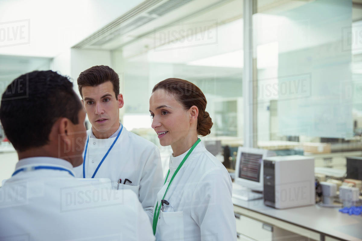 Scientists talking in laboratory - Royalty-free Stock Photo | Dissolve