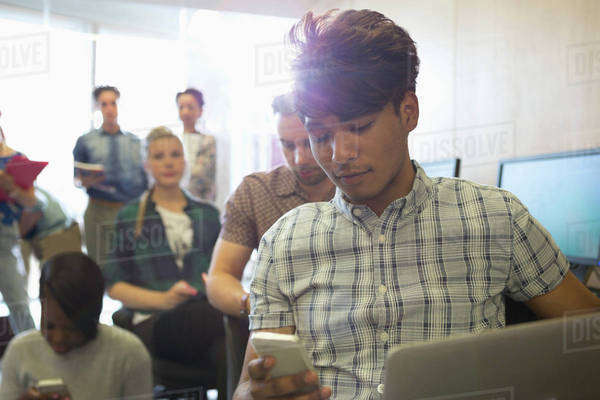 University students texting during break in classroom - Royalty-free ...