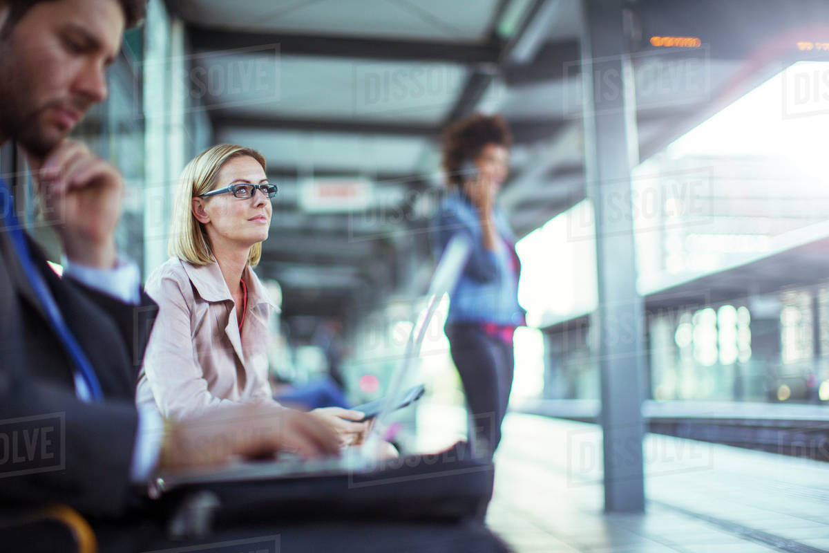 Businessman using laptop in train station - Royalty-free Stock Photo ...