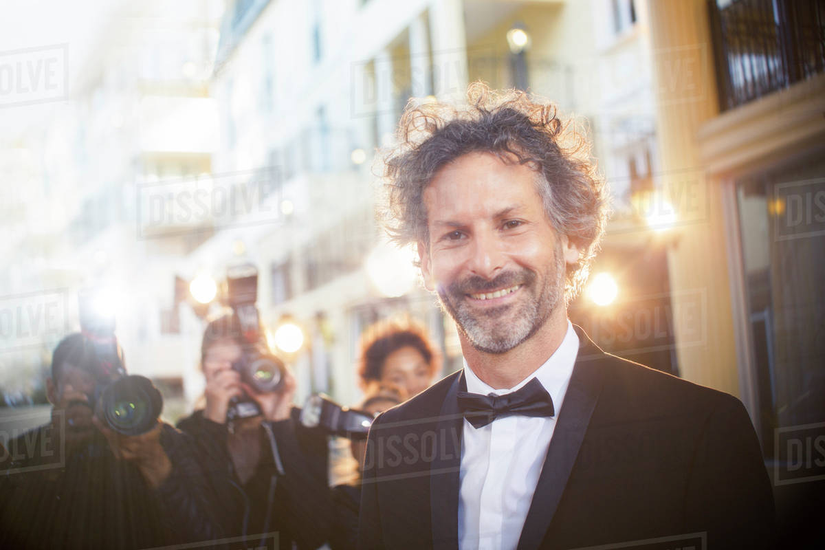 Portrait of celebrity at event with paparazzi in background - Stock ...