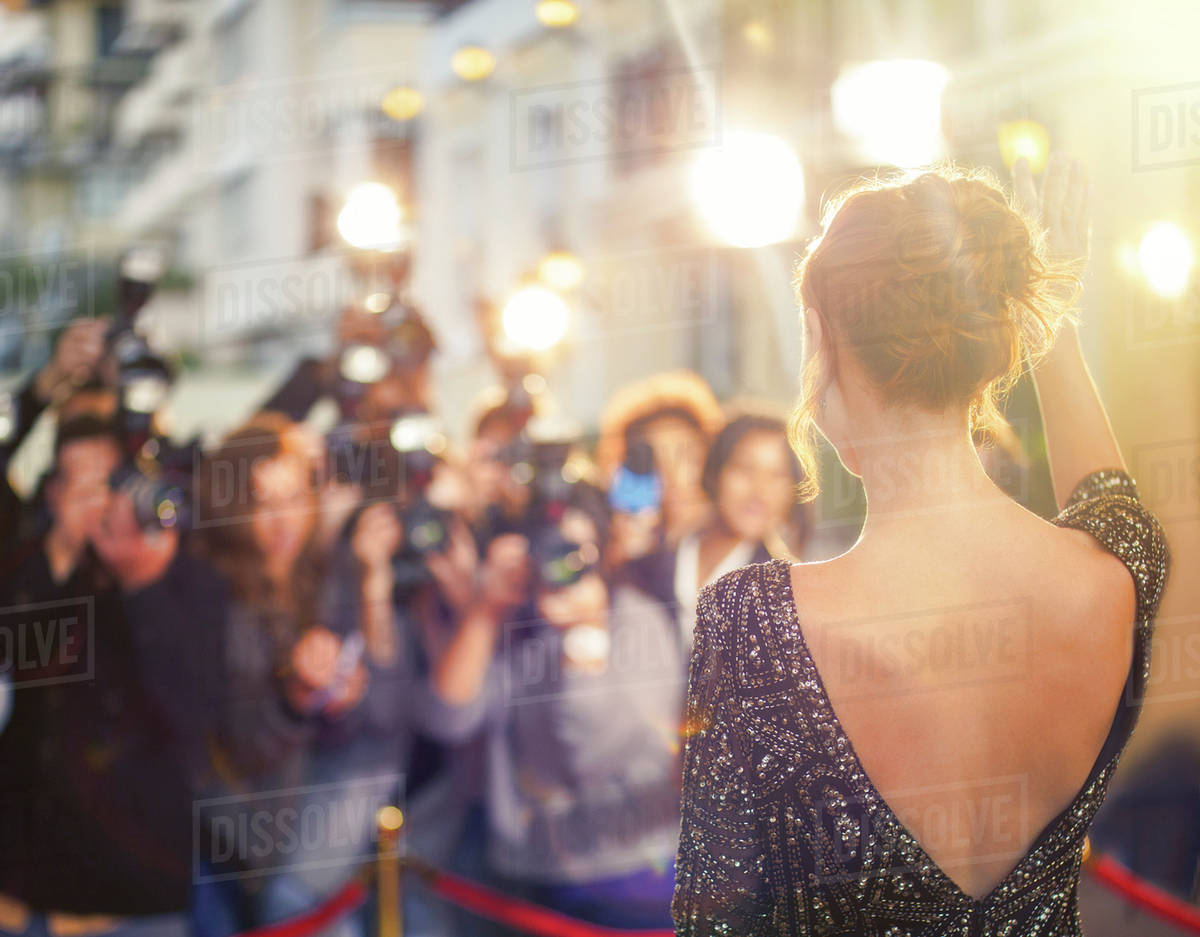 Celebrity waving at paparazzi photographers at event - Stock Photo ...