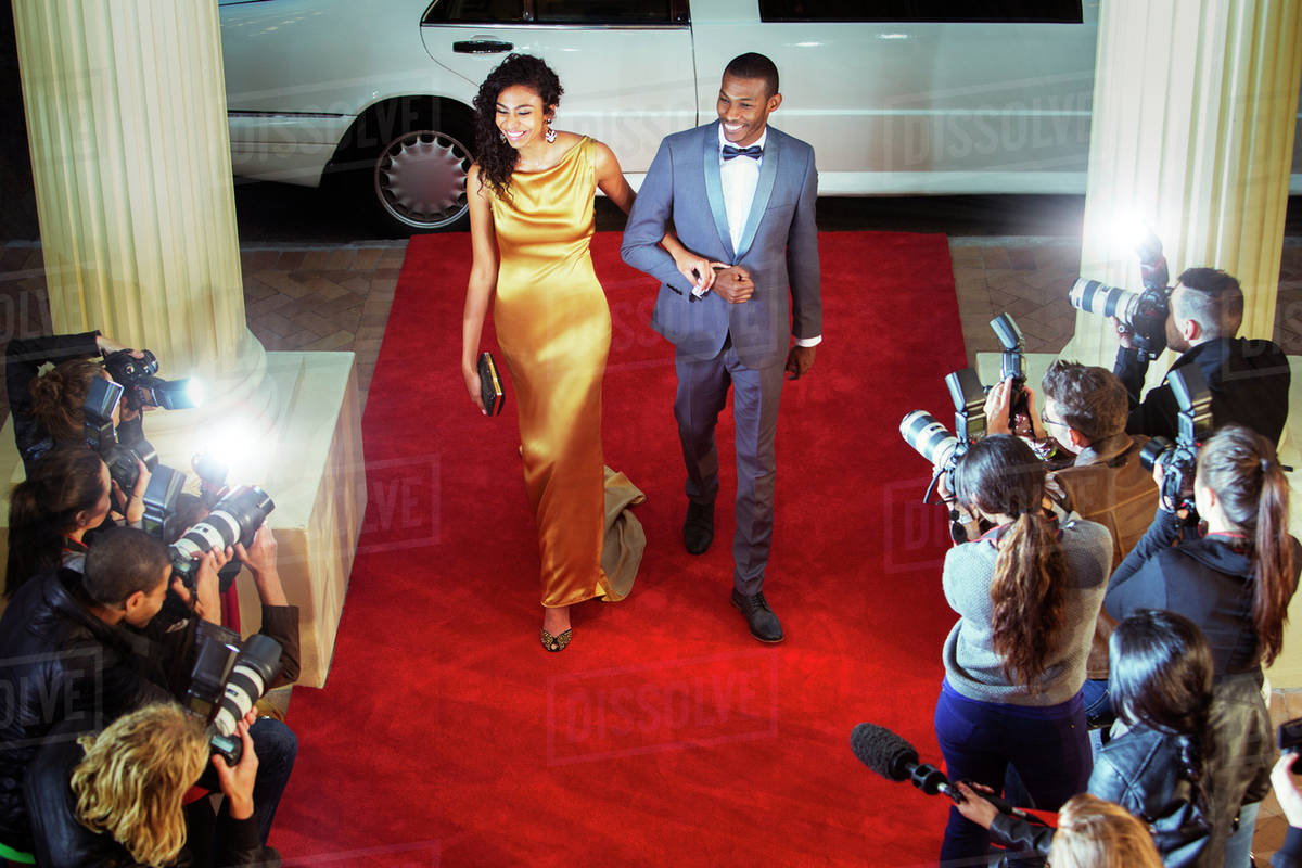Celebrity couple arriving at red carpet event and being photographed by ...