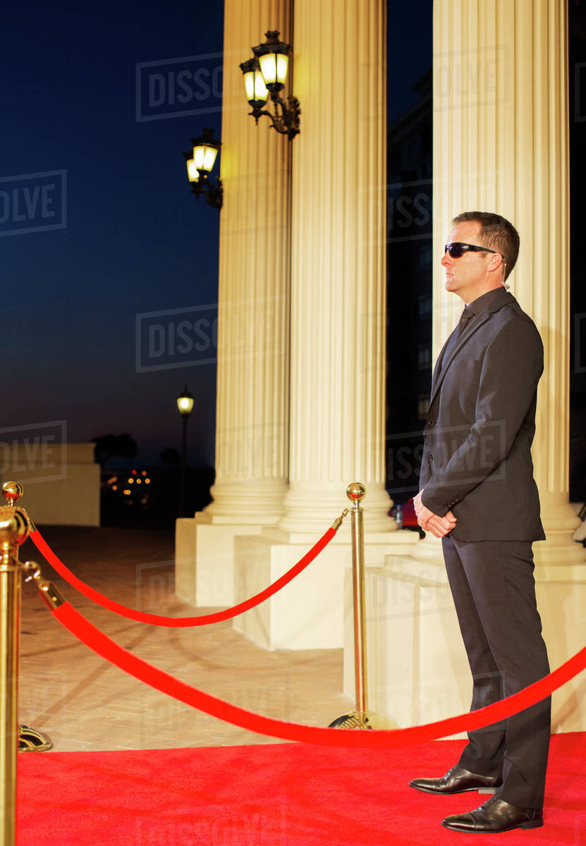 Serious bodyguard in sunglasses protecting red carpet at event - Stock ...