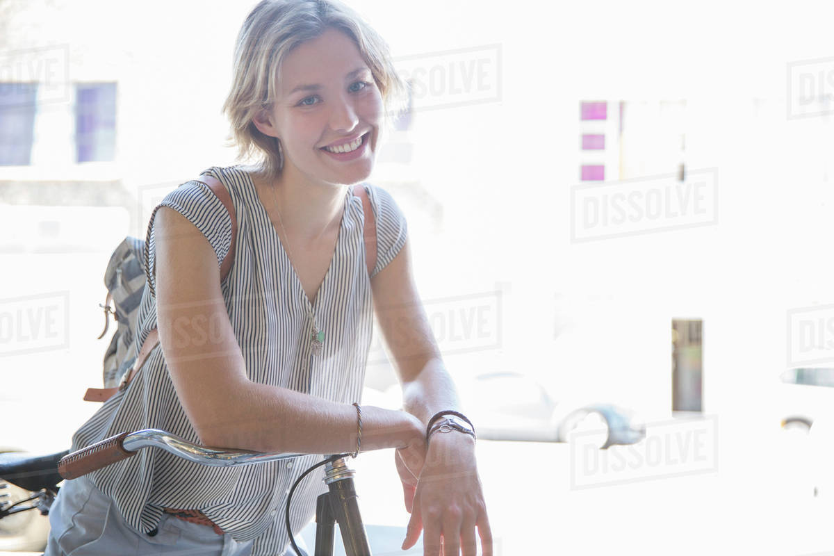 Portrait smiling woman on bicycle - Royalty-free Stock Photo | Dissolve