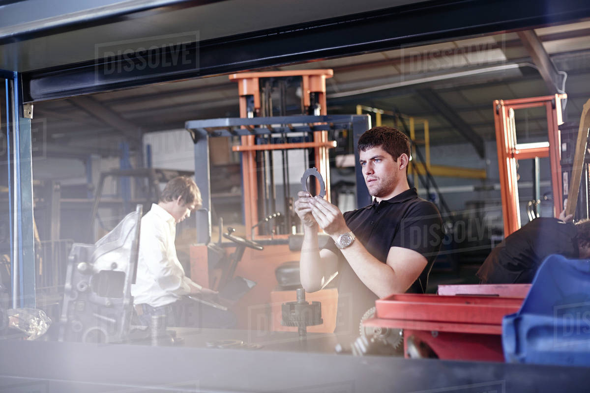 Mechanic examining part in auto repair shop - Royalty-free Stock Photo ...