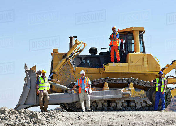 Workers on bulldozer smiling in quarry - Royalty-free Stock Photo ...