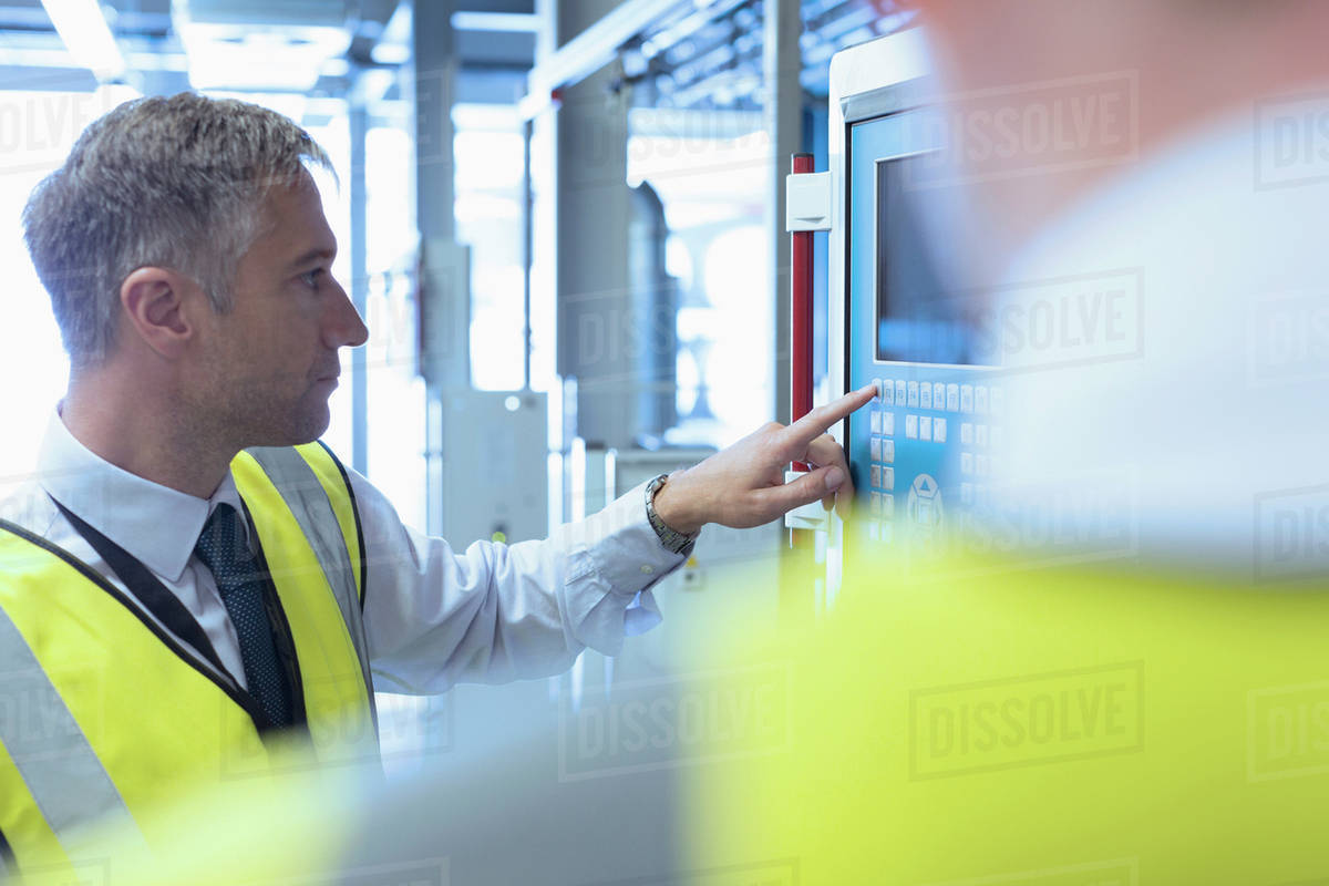 Workers at control panel in factory - Royalty-free Stock Photo | Dissolve
