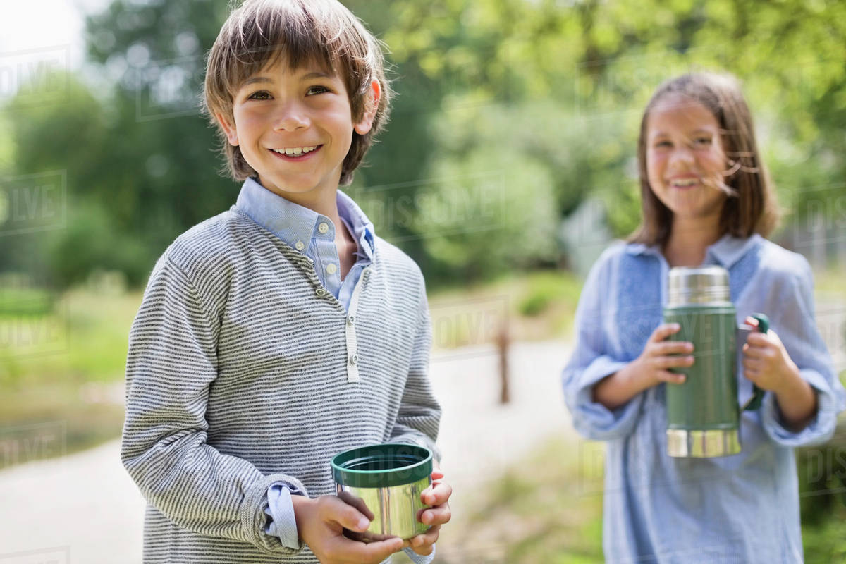 Children drinking from thermos outdoors - Royalty-free Stock Photo ...