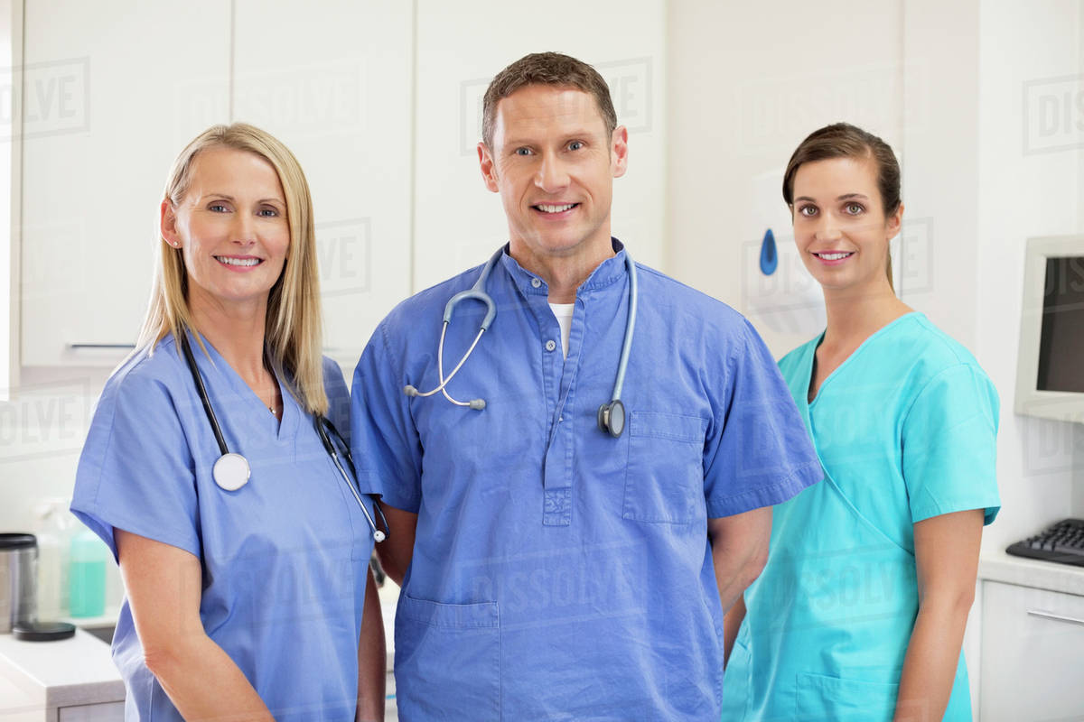 Smiling veterinarians standing together in vet's surgery - Royalty-free ...