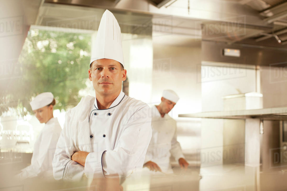 Chef standing in restaurant kitchen - Stock Photo - Dissolve
