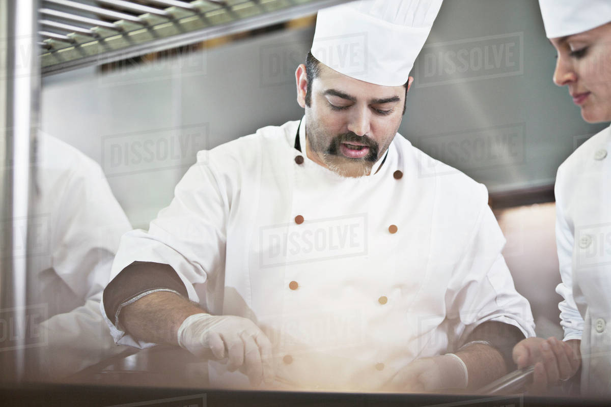 Chefs cooking in restaurant kitchen - Stock Photo - Dissolve