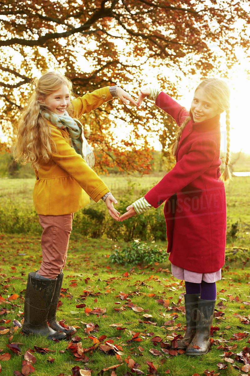 Girls making heart shape with arms outdoors - Royalty-free Stock Photo ...