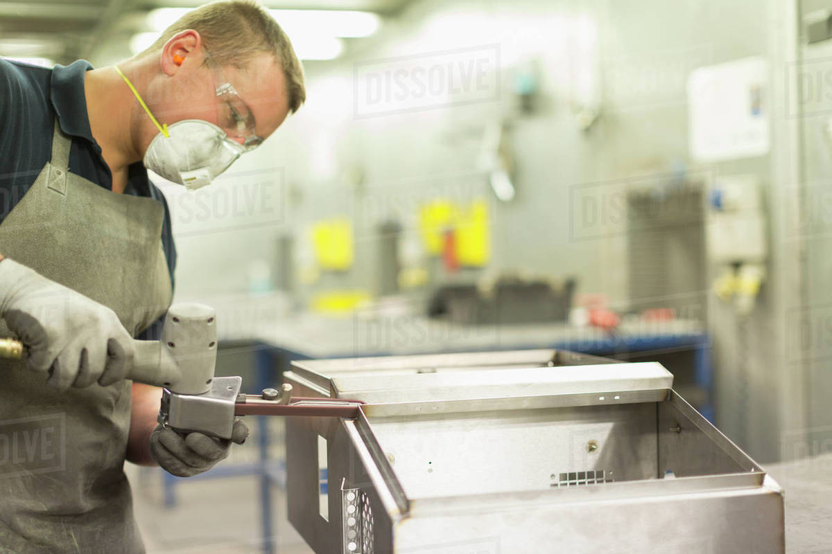 Worker using equipment in steel factory - Stock Photo - Dissolve