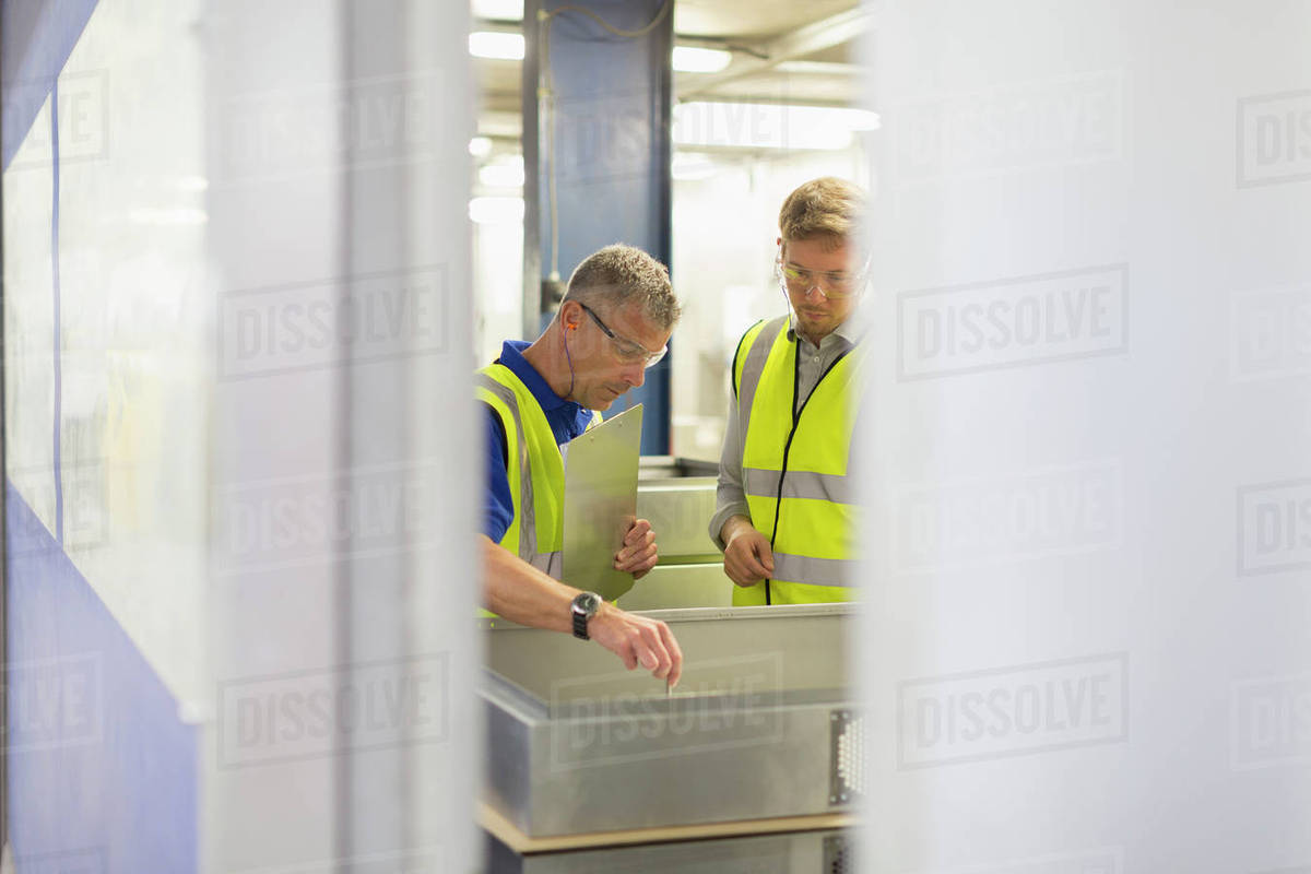 Supervisor and worker inspecting pieces in steel factory - Royalty-free ...